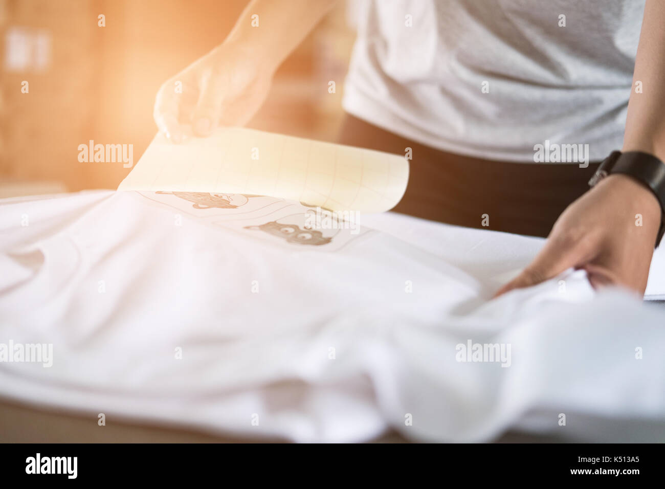 Young woman pull out paper from waterproof film on fabric. worker ...