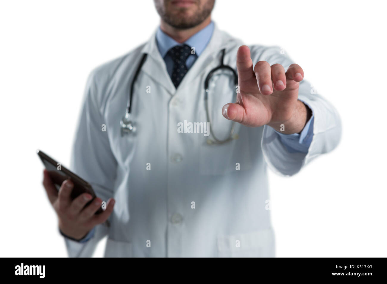 Male doctor using invisible screen against white background Stock Photo ...