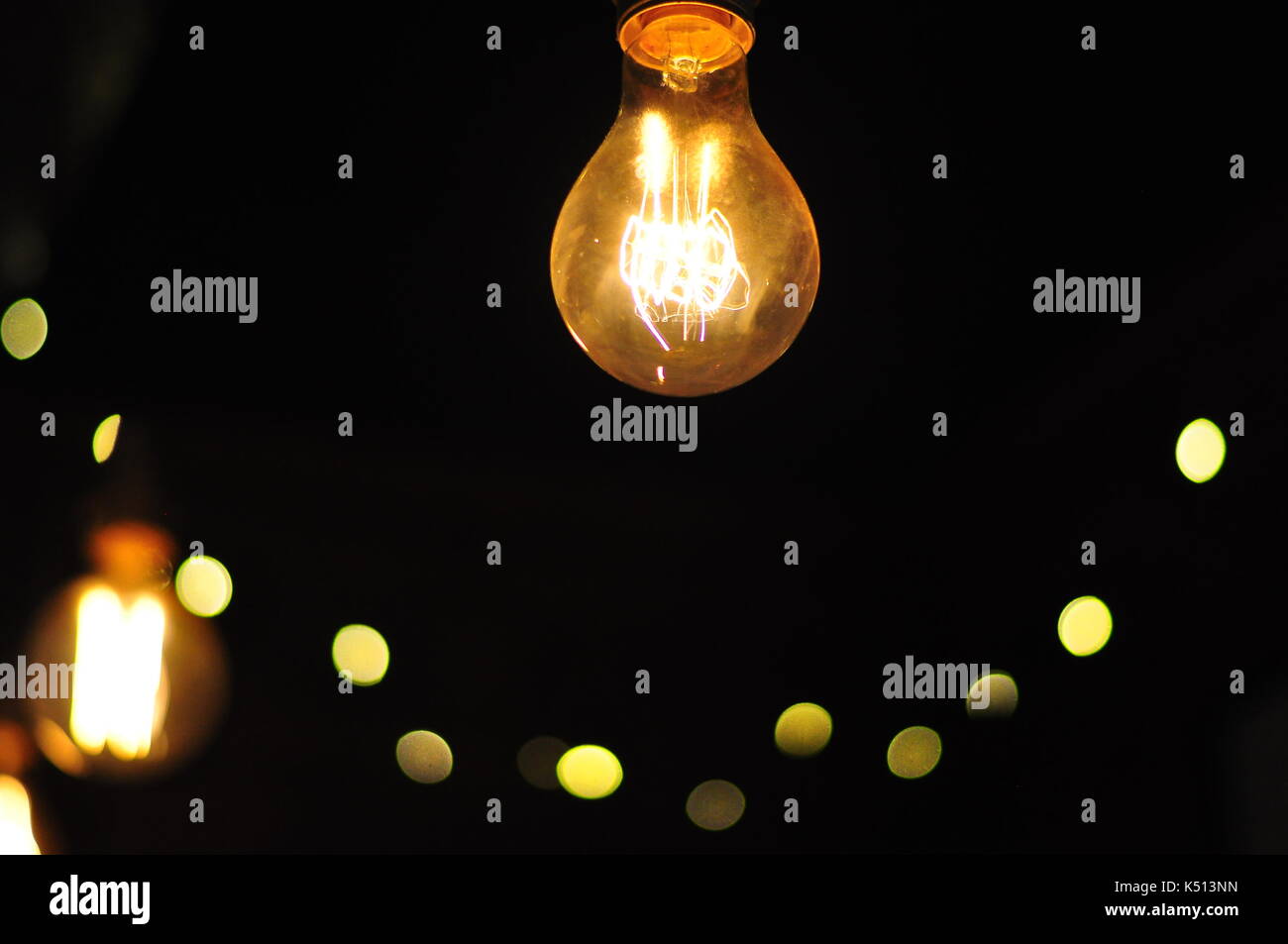 Light Bulb in focus in a dark background Stock Photo - Alamy