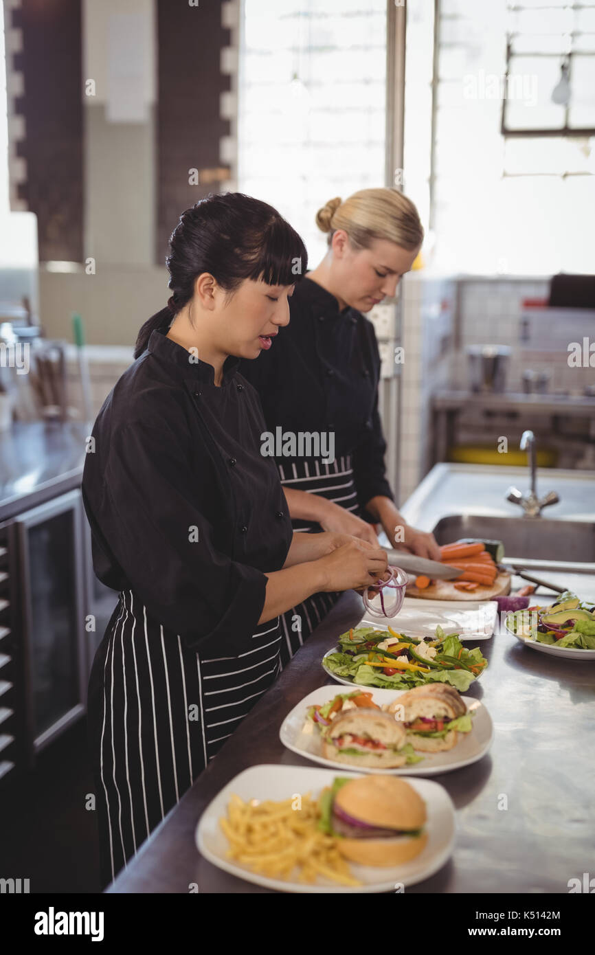 Female chefs preparing food in kitchen at coffee shop Stock Photo - Alamy