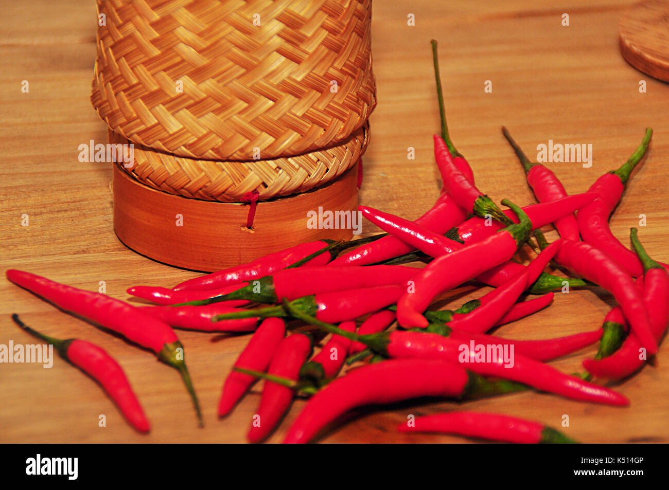 Asian pot made of sisal with red chilli peppers Stock Photo - Alamy