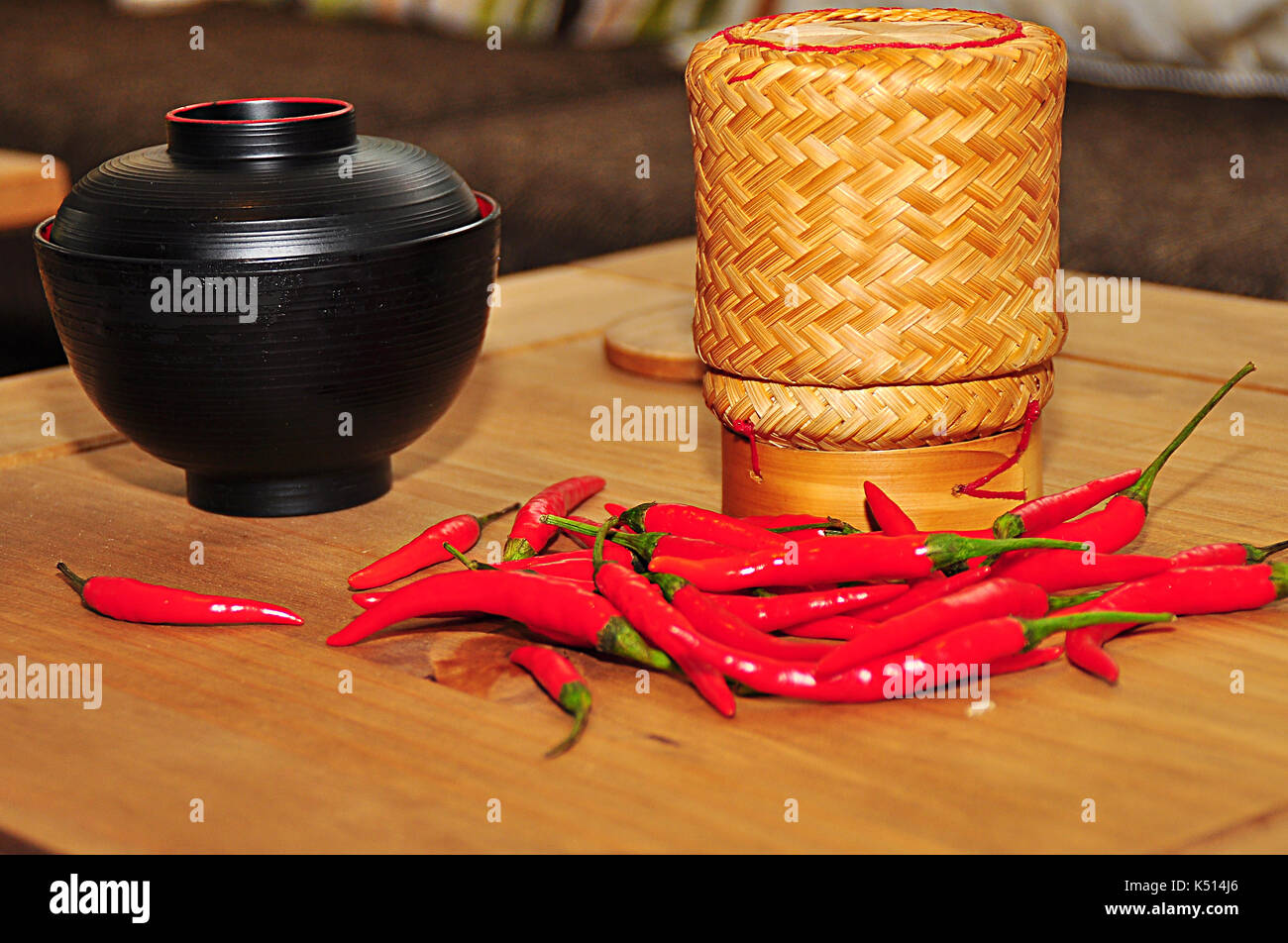 Asian pot made of sisal with red chilli peppers Stock Photo - Alamy