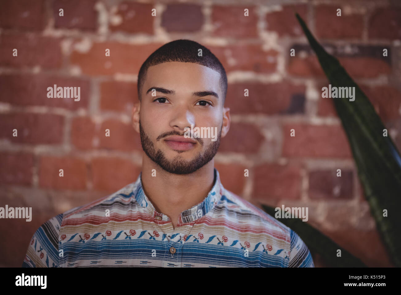 Close up portrait of confident young male customer standing against ...