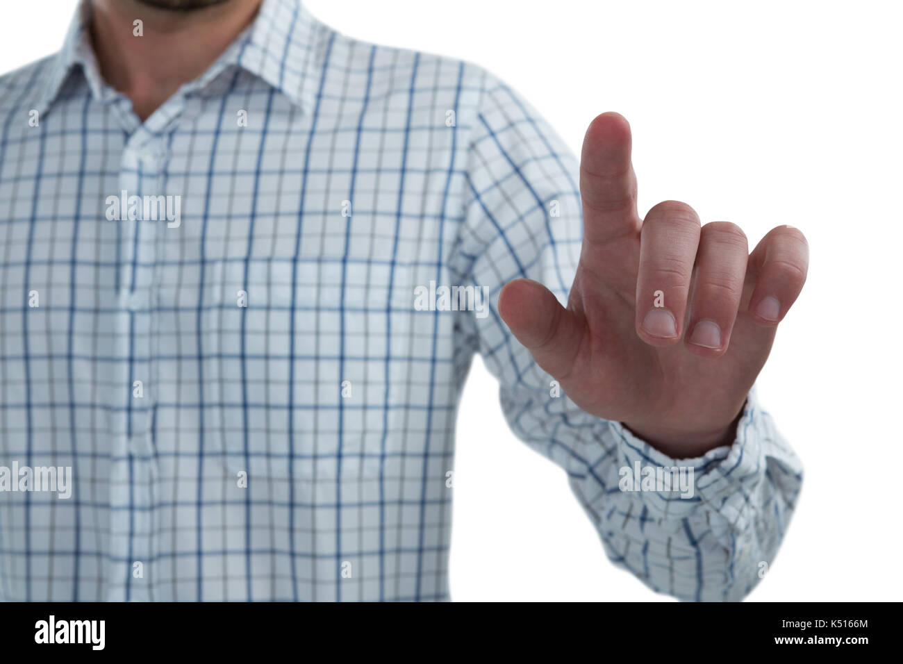 Mid-section of man pretending to touch an invisible screen against ...