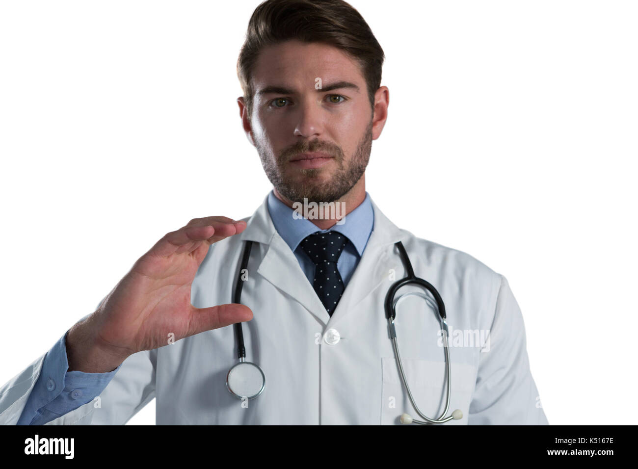Male doctor pretending to hold an invisible object against white ...