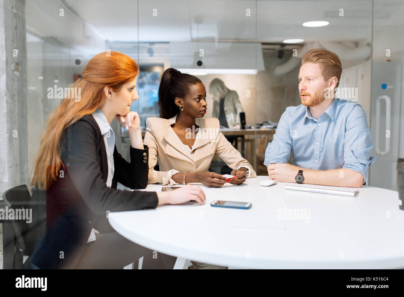 Group work colleagues sitting table hi-res stock photography and images ...