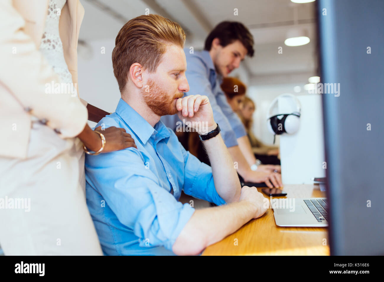 Supervising colleague during work Stock Photo - Alamy
