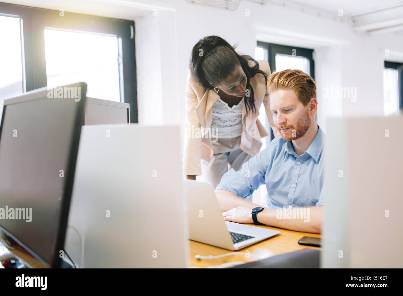 Supervising colleague during work Stock Photo - Alamy