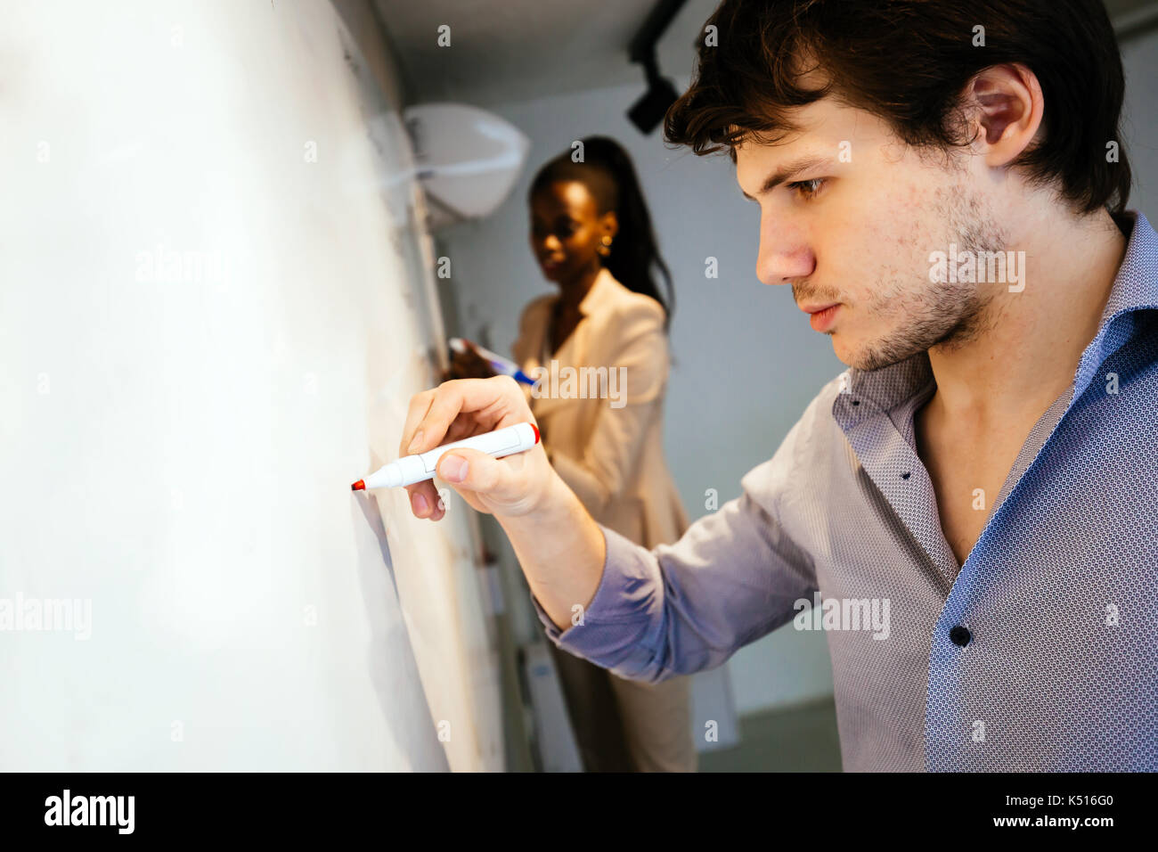 Women writing on whiteboard hi-res stock photography and images - Alamy