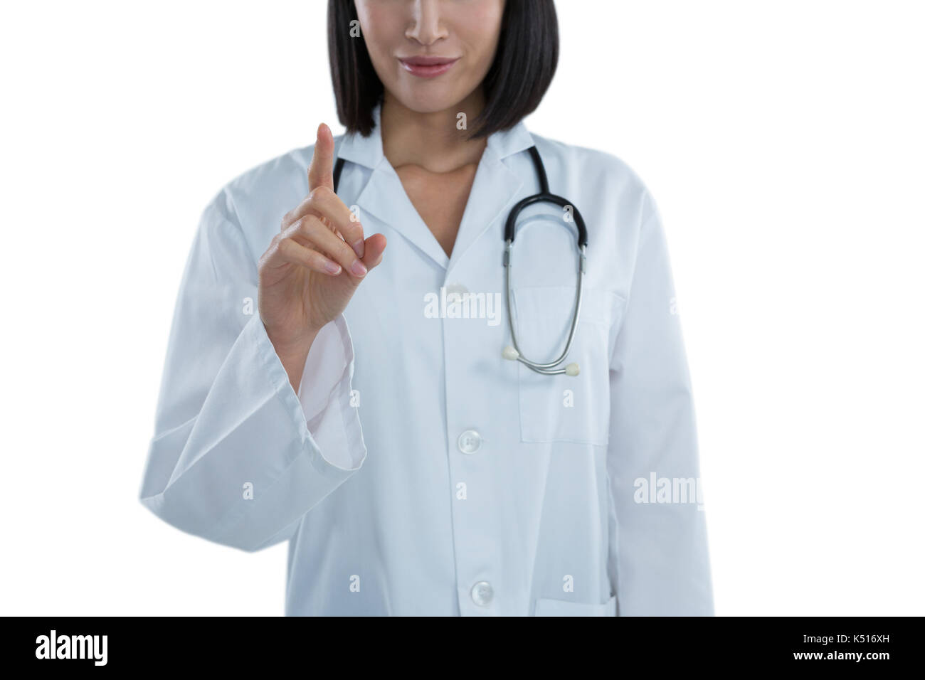 Mid section of female doctor touching invisible screen against white ...