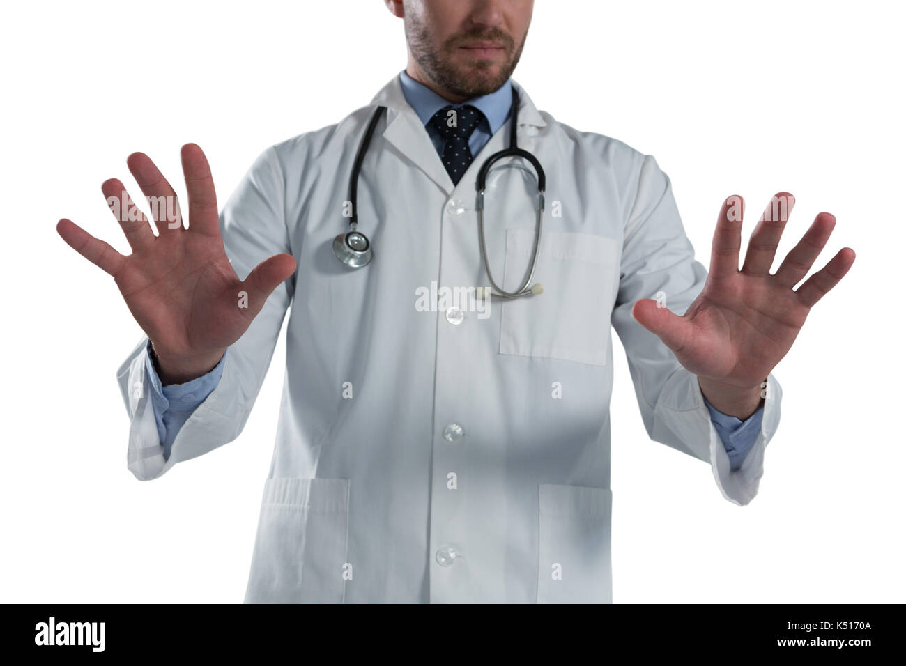 Male doctor using invisible screen against white background Stock Photo ...