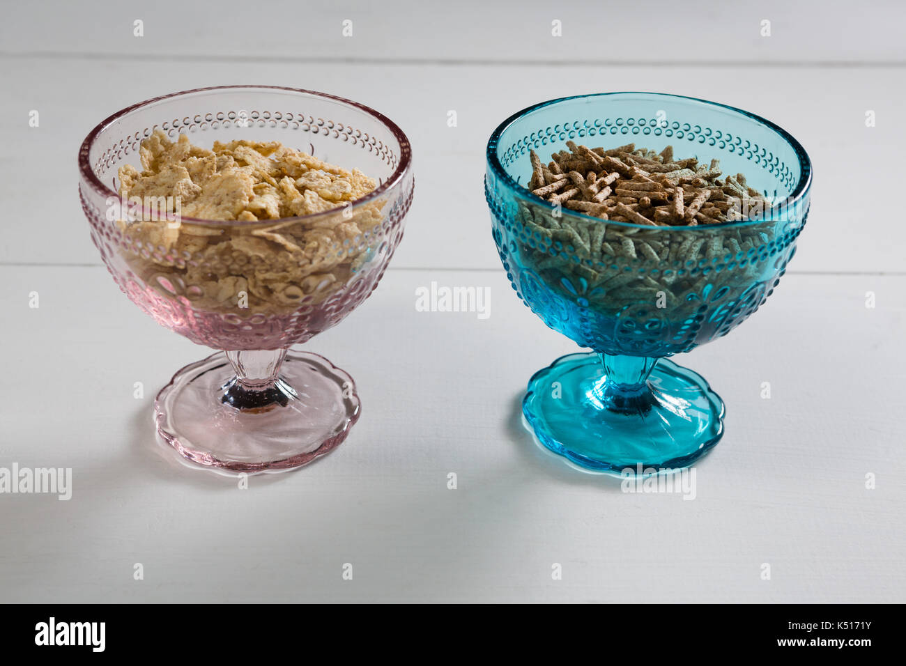 Wheat flakes and cereal bran sticks in bowl on white background Stock ...