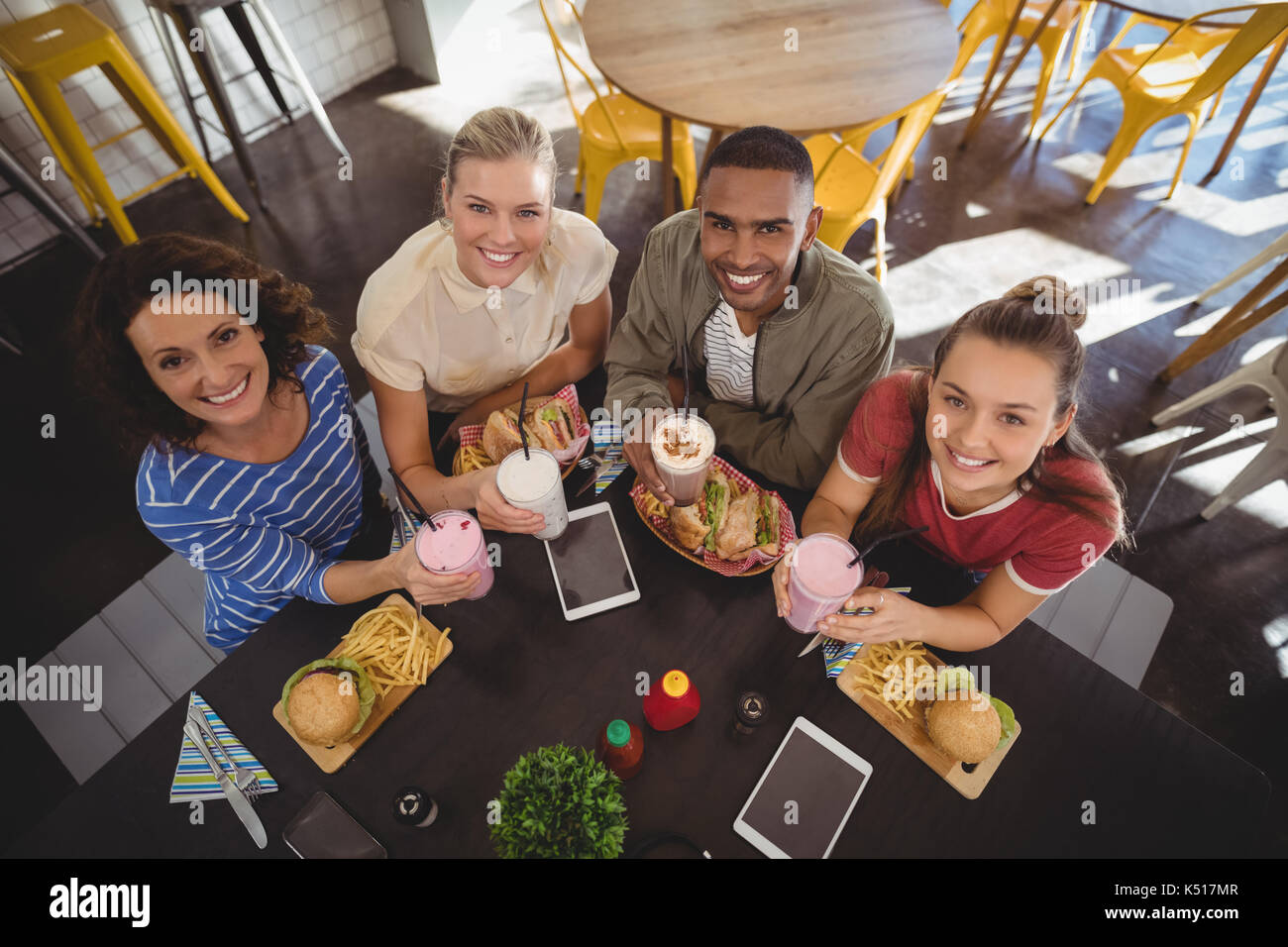 Smiling friends eating french hi-res stock photography and images - Alamy