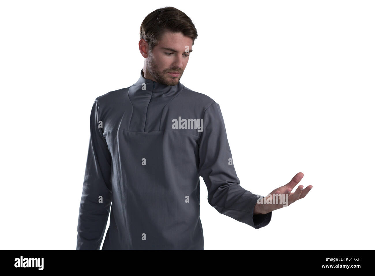 Man pretending to hold an invisible object against white background ...