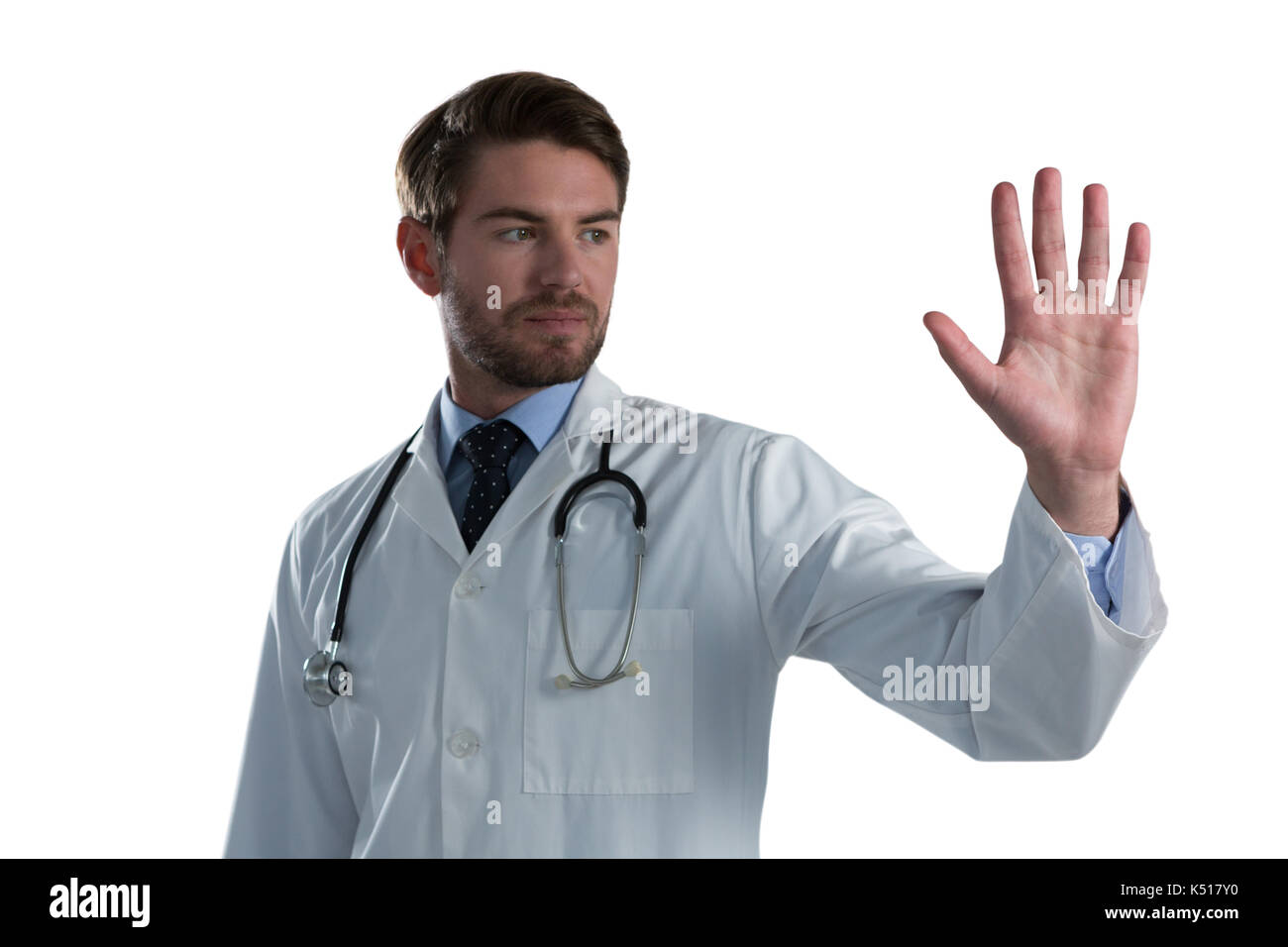 Male doctor using invisible screen against white background Stock Photo ...