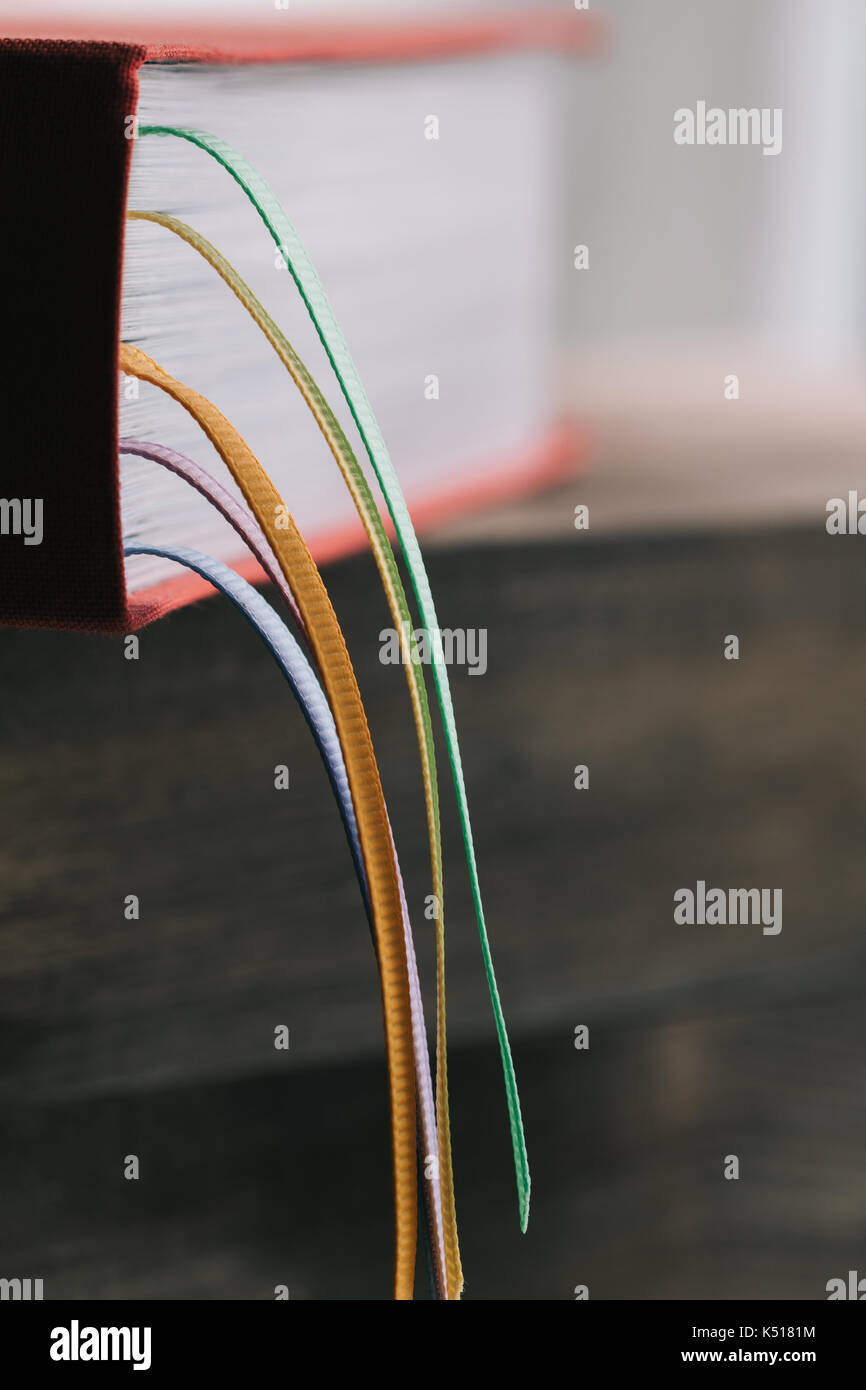 Closeup of the back of a book with colored bookmarks Stock Photo - Alamy