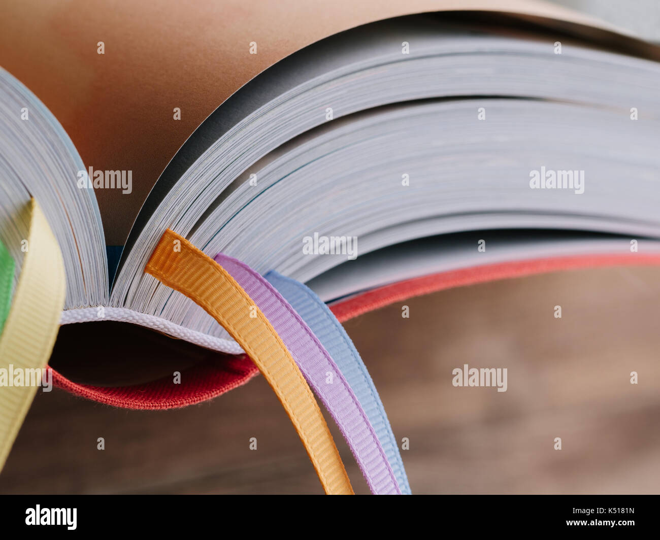 Closeup of the back of a book with colored bookmarks Stock Photo - Alamy