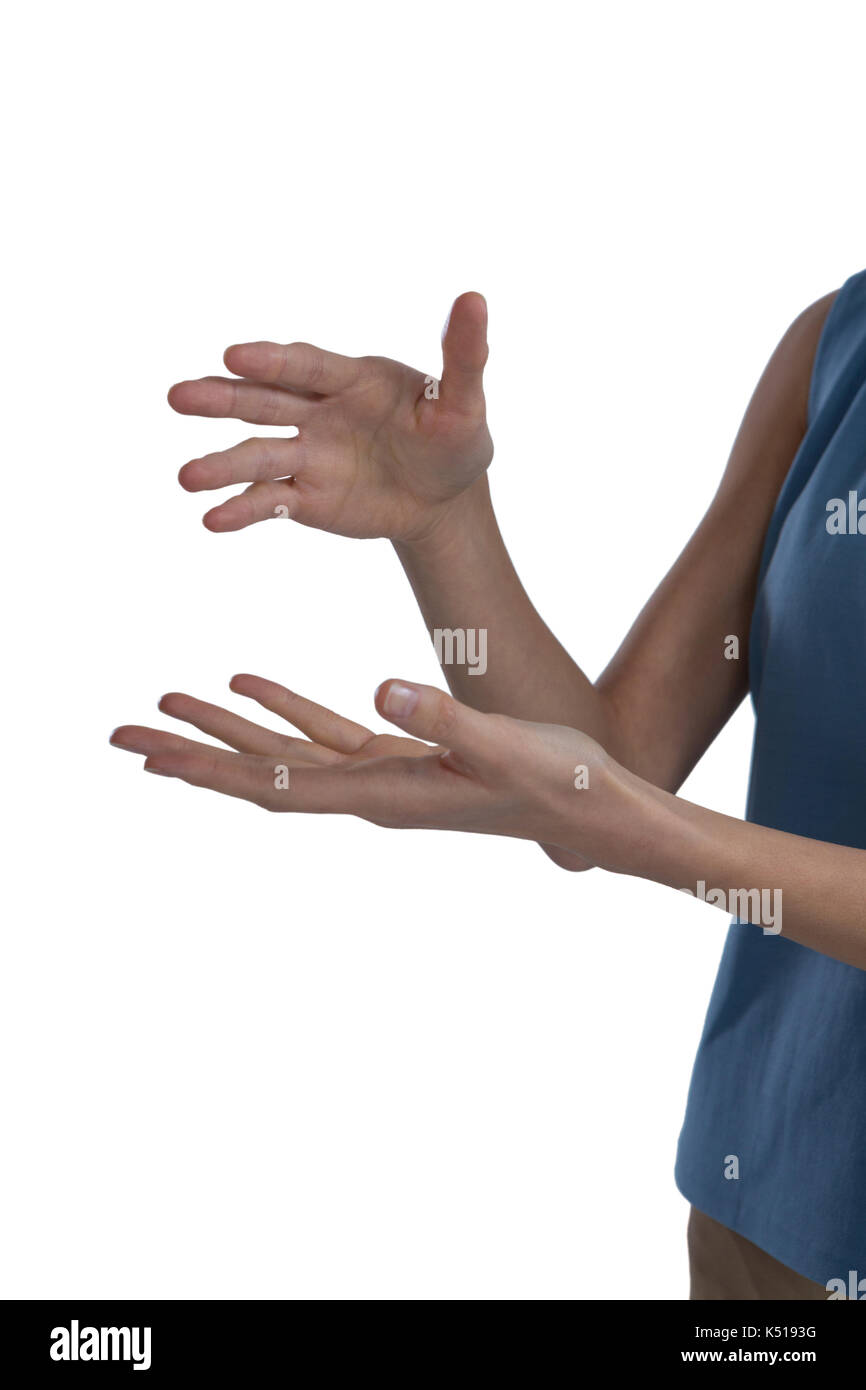 Female executive pretending to hold invisible object against white ...