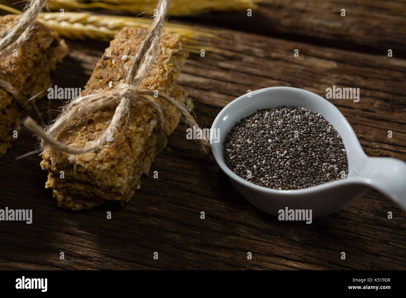 Close-up of granola bars tied with string and grains on spoon Stock ...