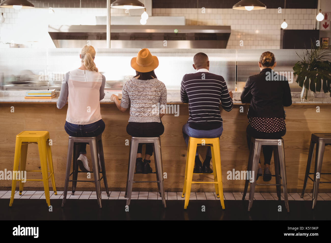 Woman sitting rear view stool hi-res stock photography and images - Alamy