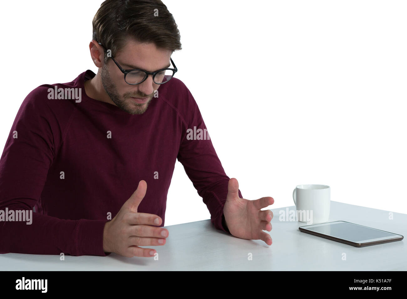 Man pretending to hold an invisible object against white background ...