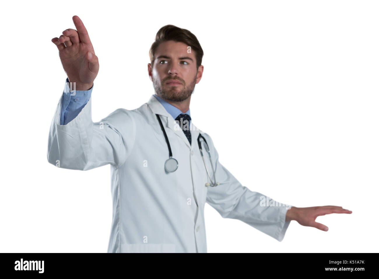 Male doctor using invisible screen against white background Stock Photo ...
