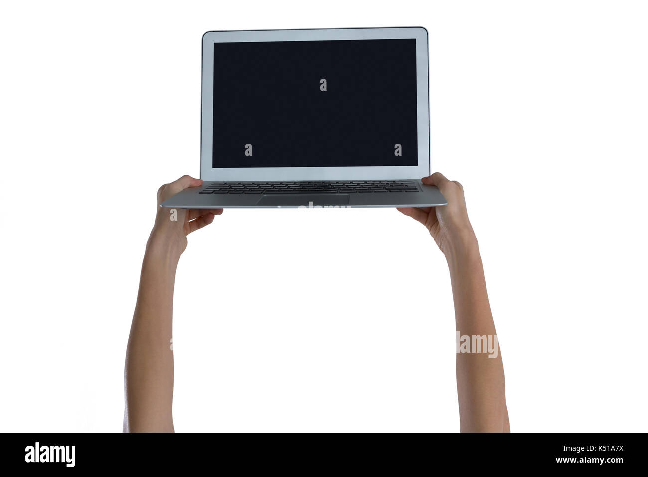 Womans hand holding laptop against white background Stock Photo - Alamy