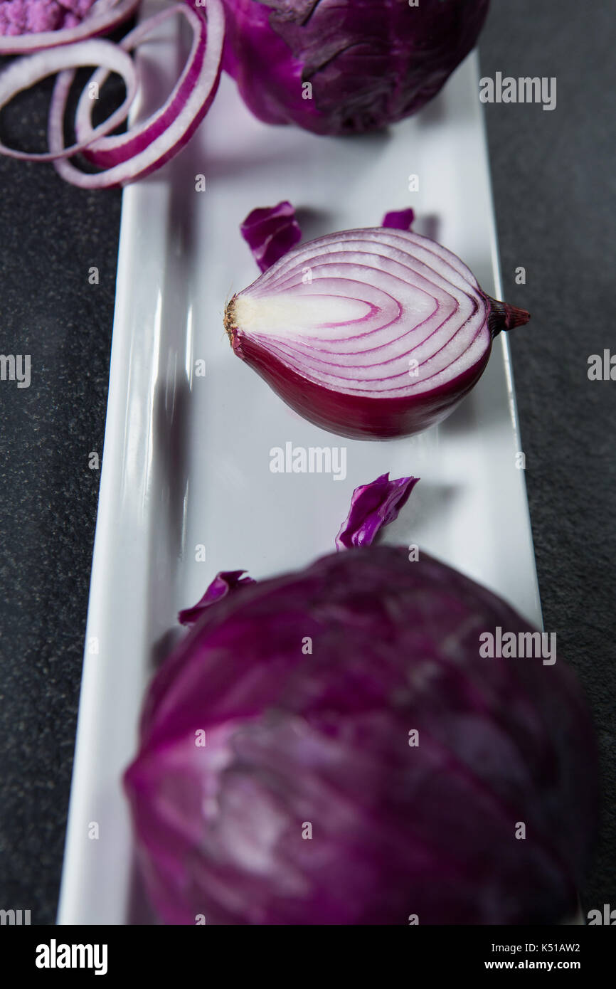 Close-up of onion with red cabbage in white plate on slate Stock Photo ...