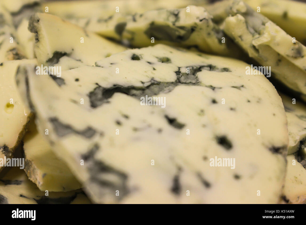 Blue cheese slices in close up background Stock Photo - Alamy