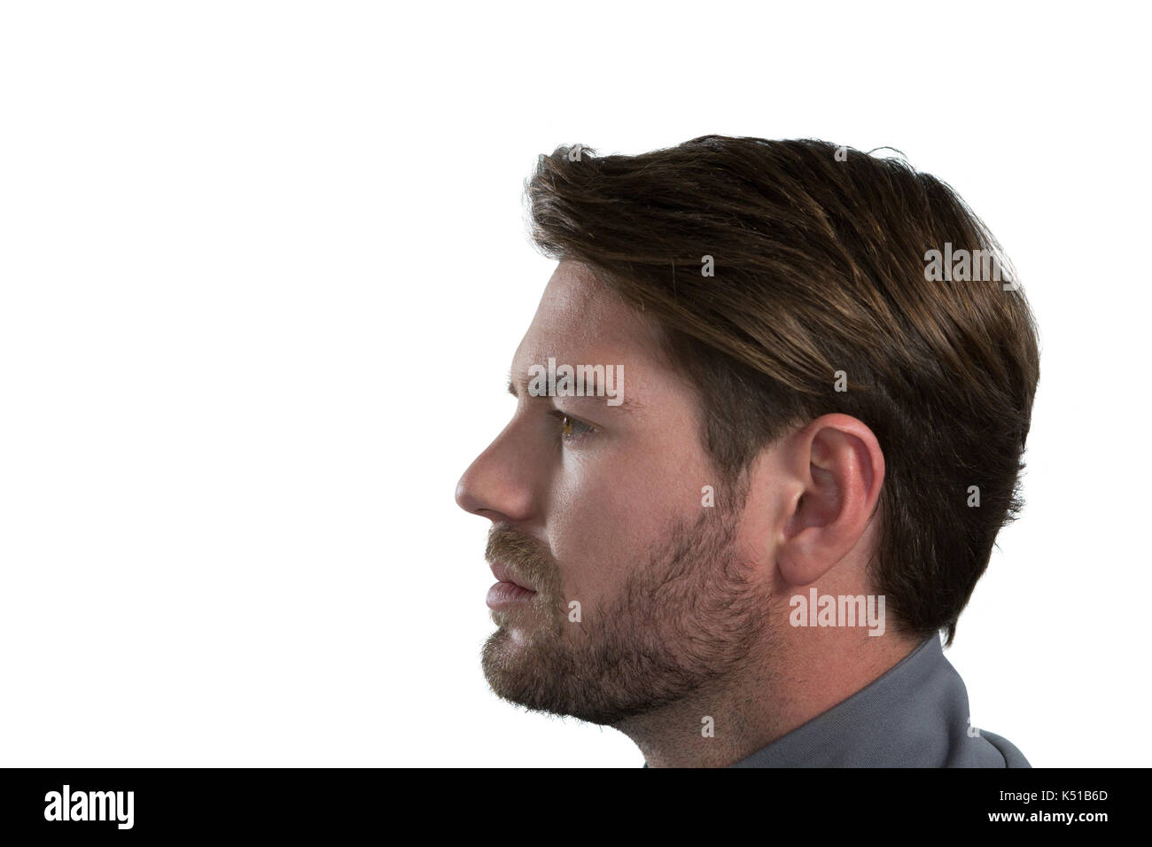 Side view of man standing against white background Stock Photo - Alamy