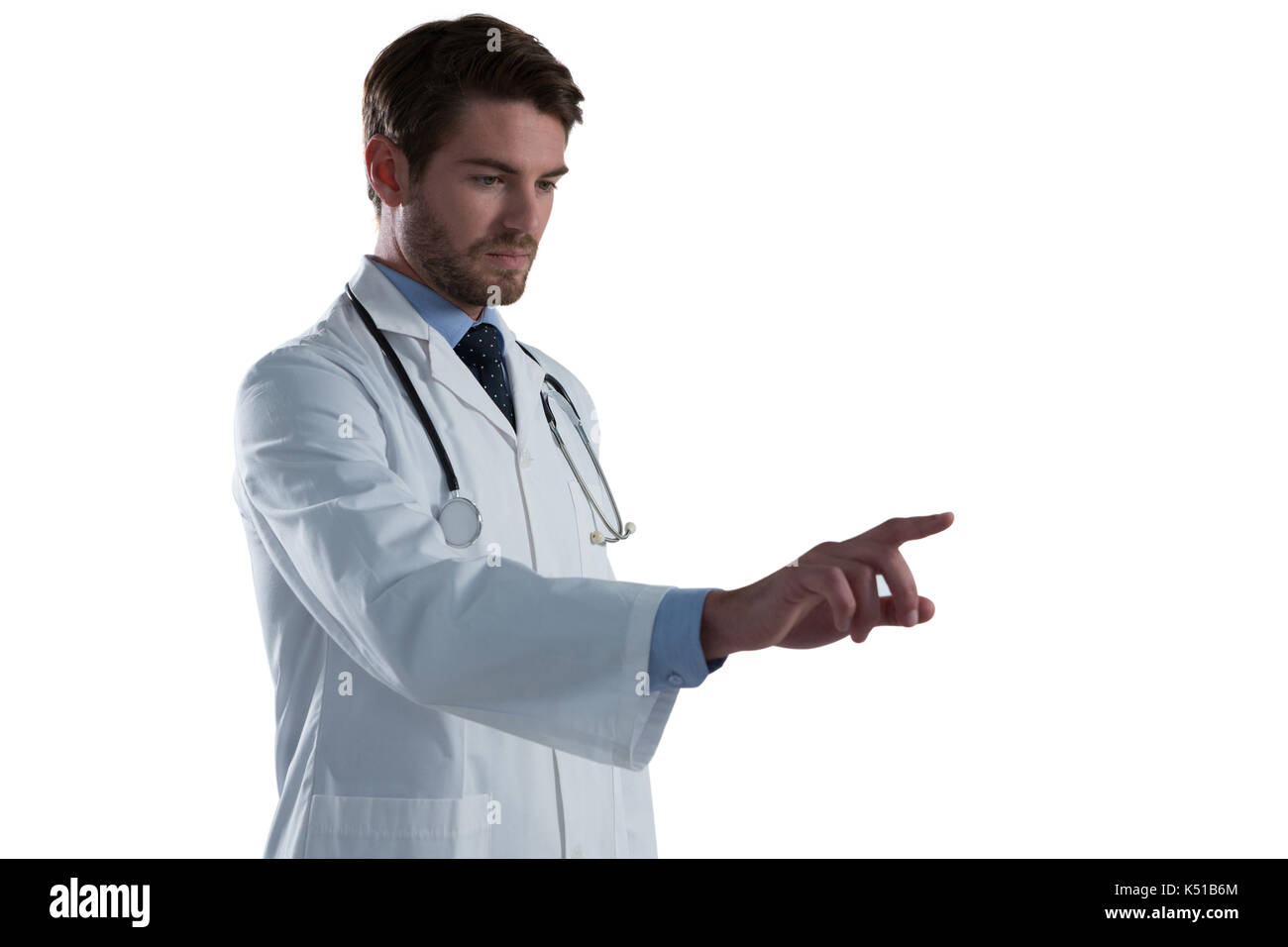 Male doctor using invisible screen against white background Stock Photo ...