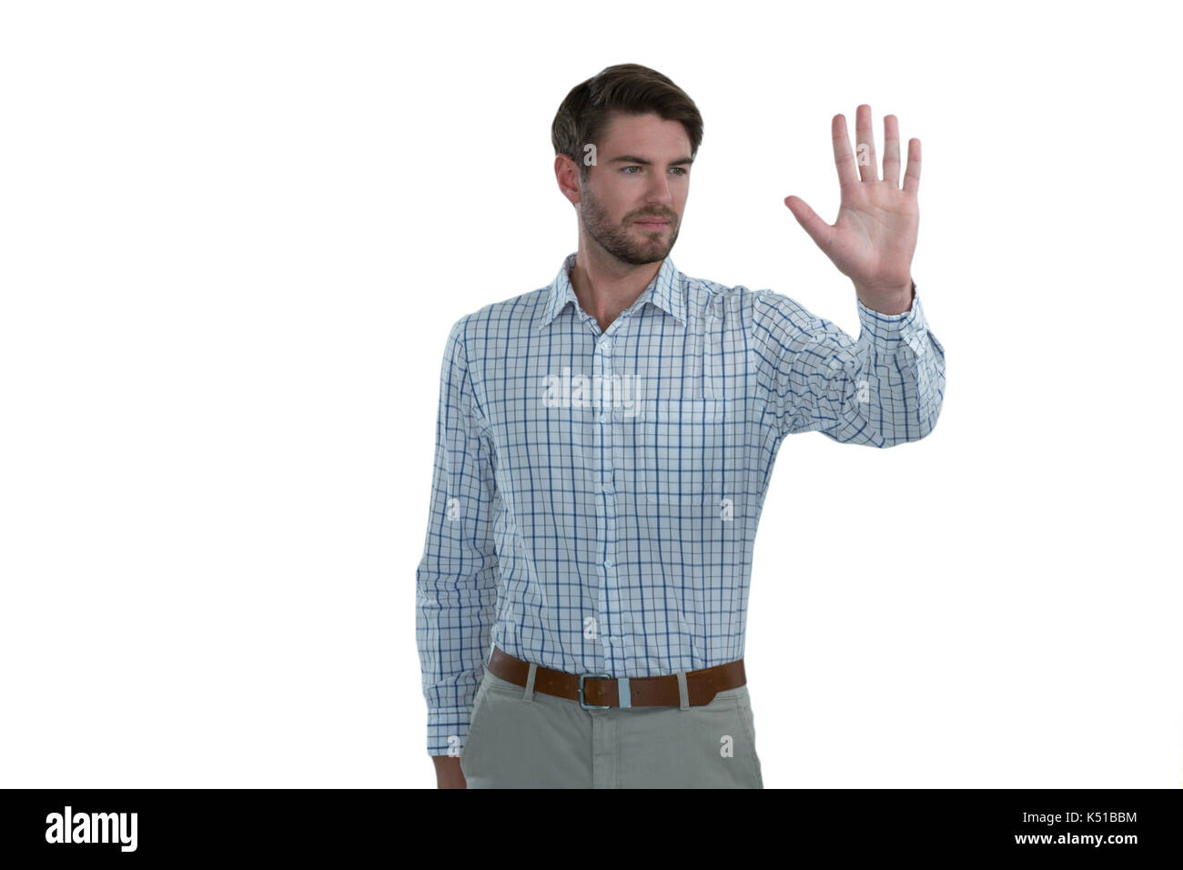 Handsome man gesturing stop sign against white background Stock Photo ...