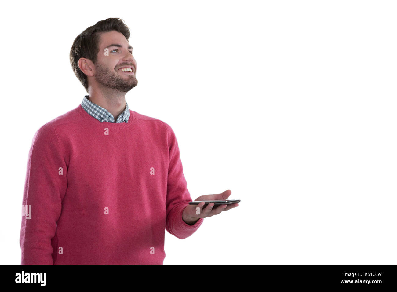 Happy man holding mobile phone against white background Stock Photo - Alamy