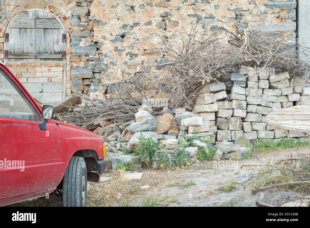 Old rusty red car parked near the wall Stock Photo - Alamy