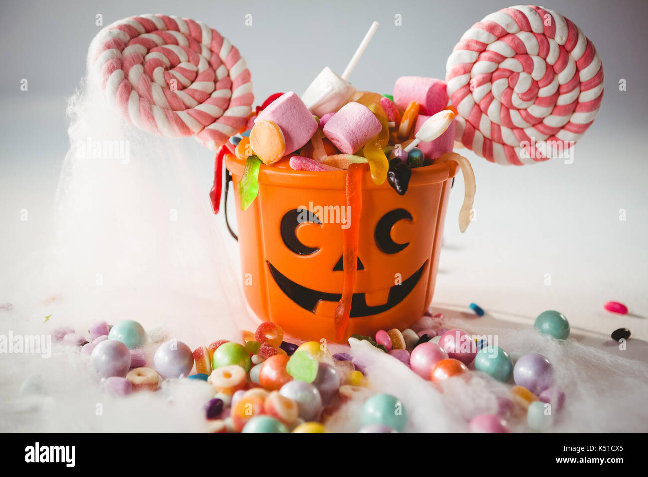 Bucket with various sweet food over white background Stock Photo - Alamy