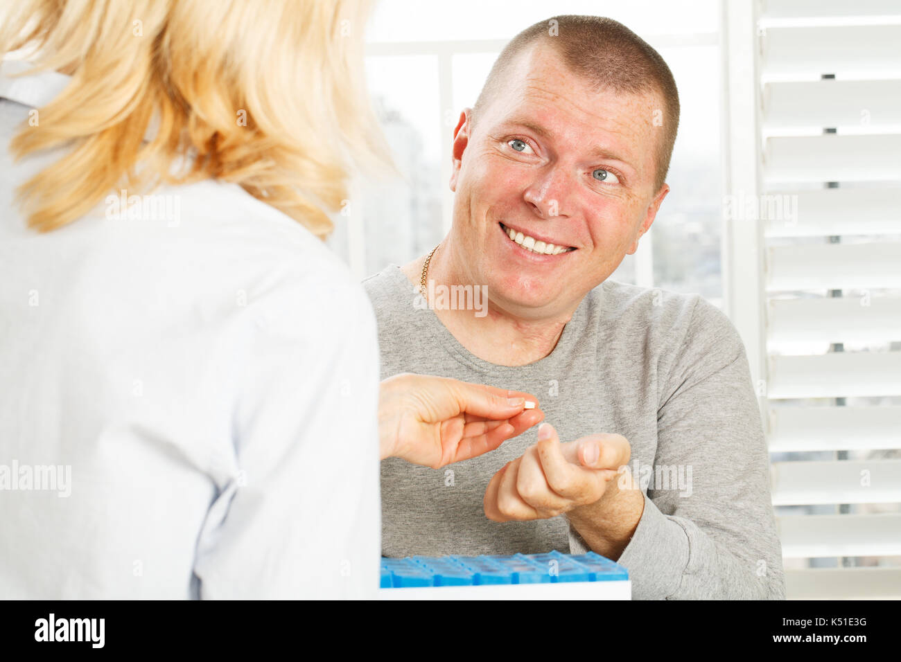 Hand of nurse giving patient medication Stock Photo - Alamy