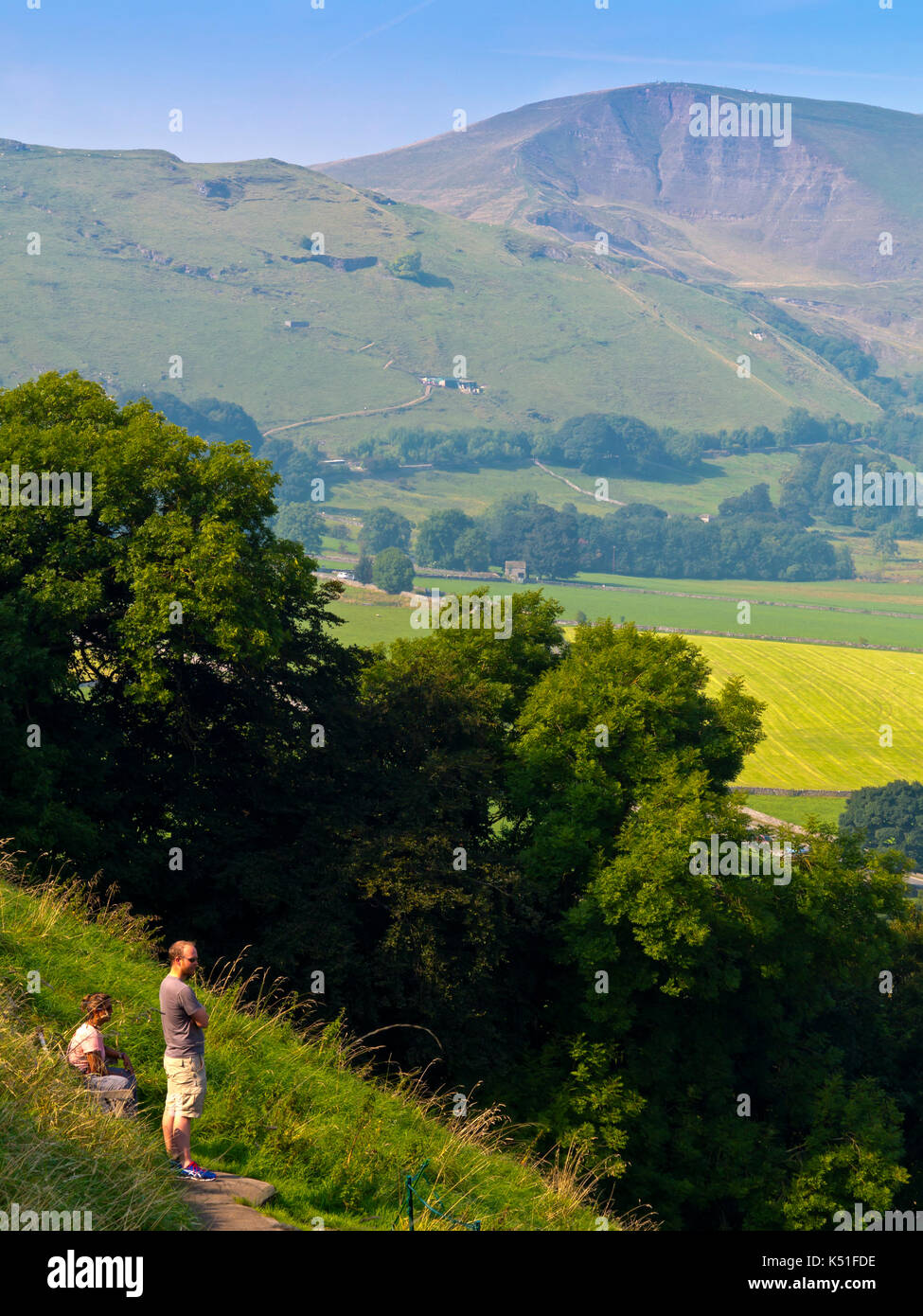 Couple enjoying the view looking towards Mam Tor from Castleton in the ...