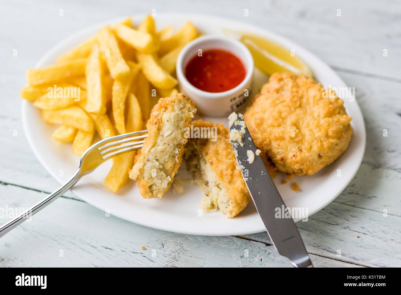 Fishcakes with chips Stock Photo - Alamy
