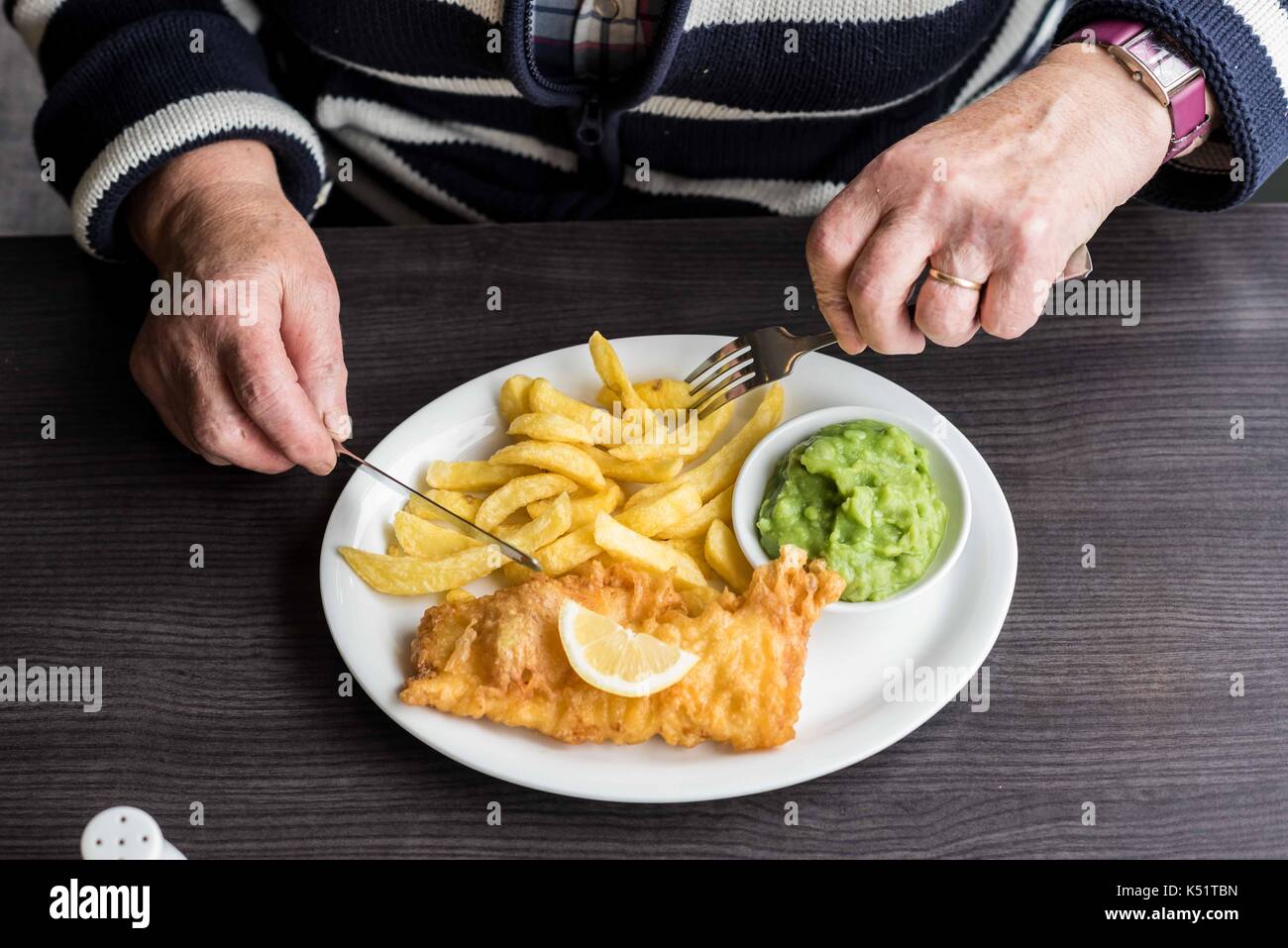 Eating fish and chips with hands hi-res stock photography and images ...