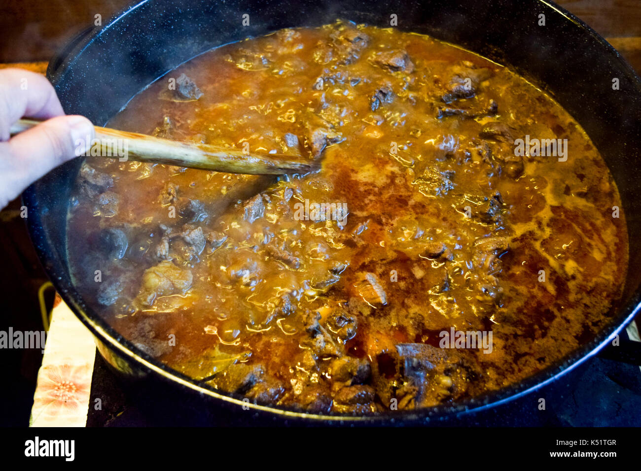Male hand mixing a stew Stock Photo - Alamy