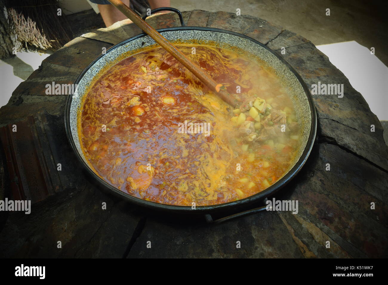 Male hand mixing a stew Stock Photo - Alamy
