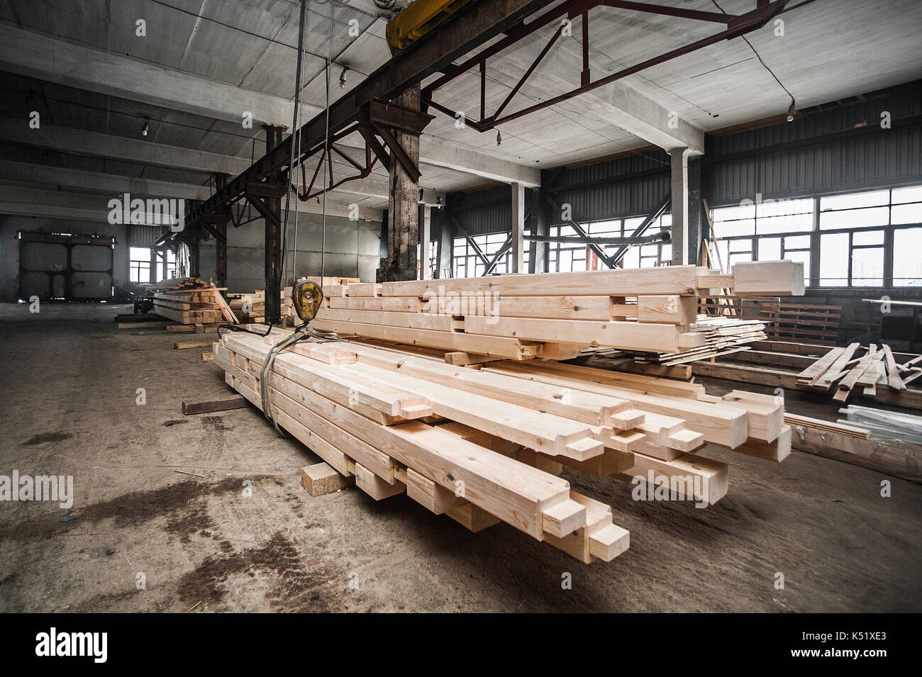 Stack wood beams in the factory. A stack of new processed bars in the ...