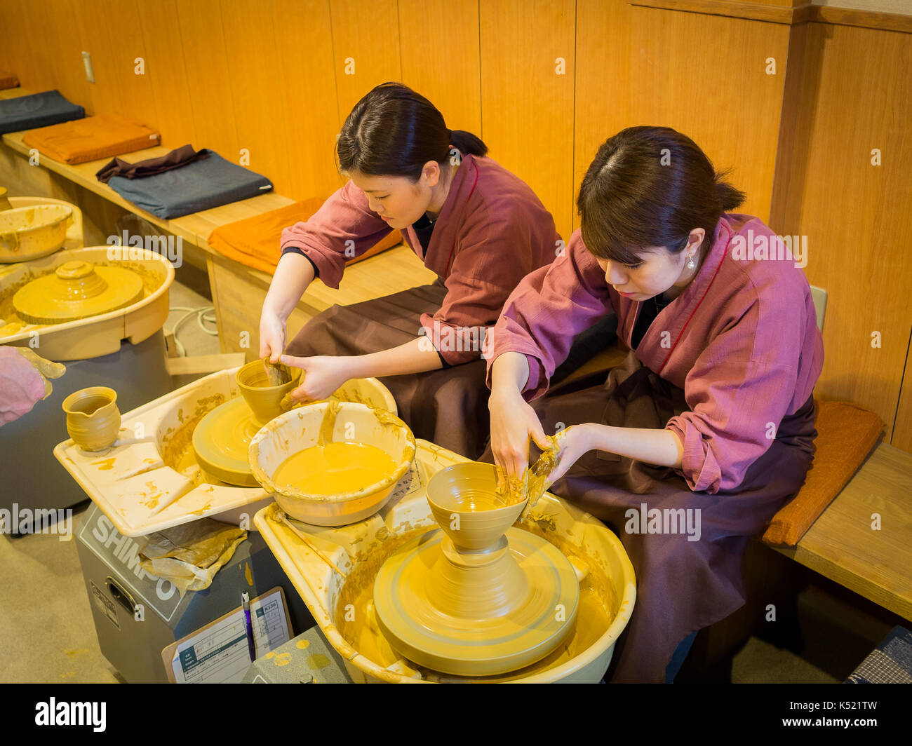 HAKONE, JAPAN - JULY 02, 2017: Asian women sculpts in clay pot closeup ...