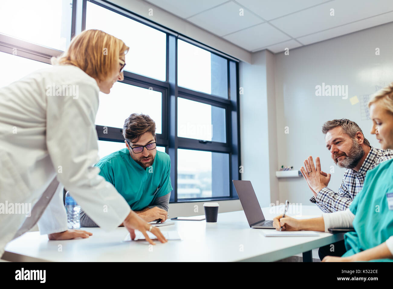 Medical team interacting at a meeting. Medical staff meeting in ...