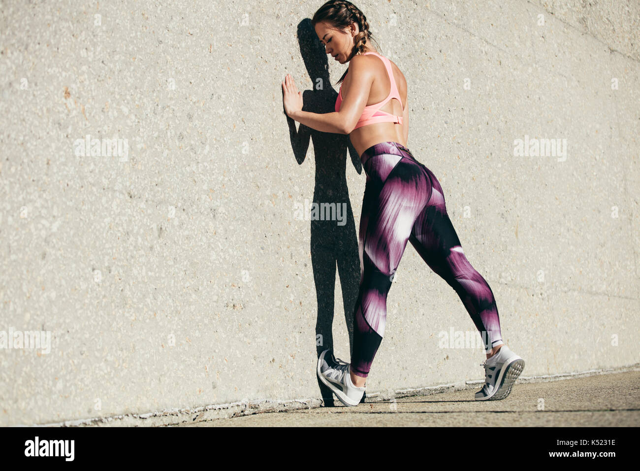 Person stretching against wall hi-res stock photography and images - Alamy