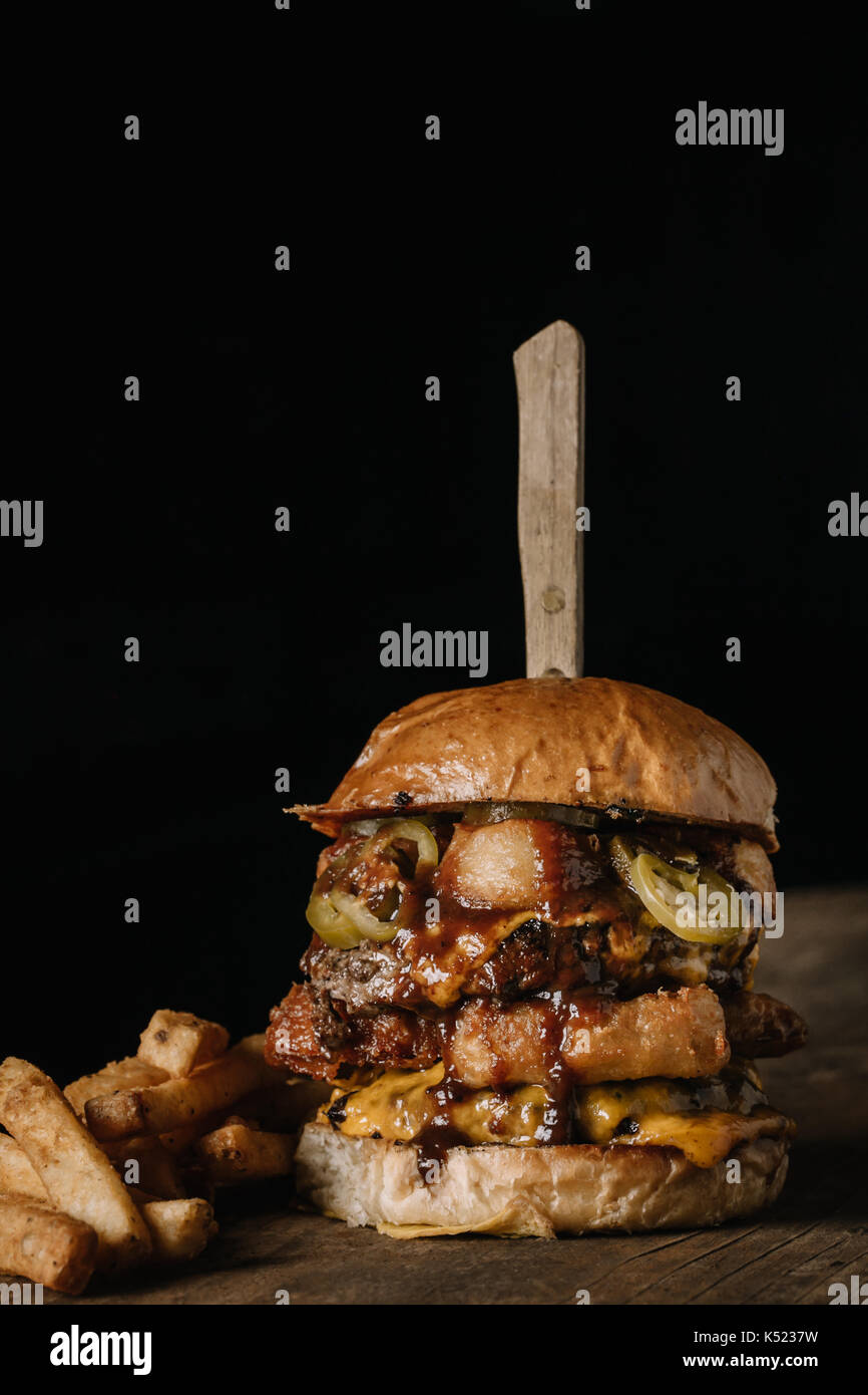 Double Meat Burger with fried onion rings, cheese and pickled jalapeños ...