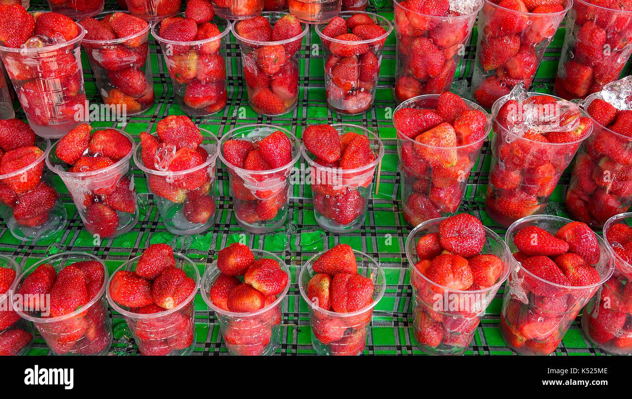 Cups of fresh red strawberries for sale at the Chatuchak Weekend Market ...