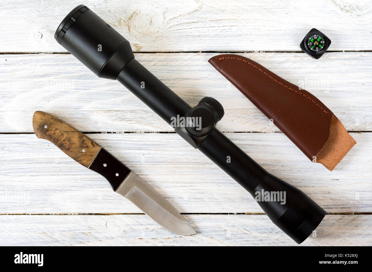 Optical sight and hunting knife on a white background. Flat lay Stock ...