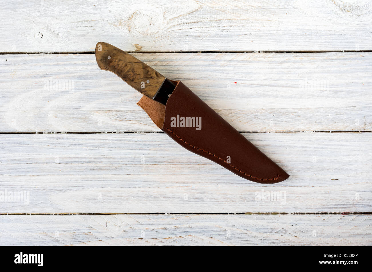 Hunting knife in leather sheath. Hunter's knife on withe wood Stock ...