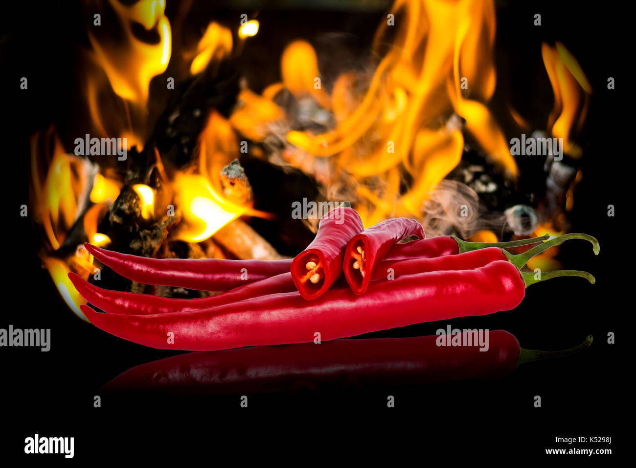 hot red pepper over a flame background Stock Photo - Alamy